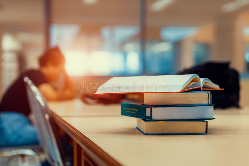 Open Book on Stack of Books in Library at School, University, College ...