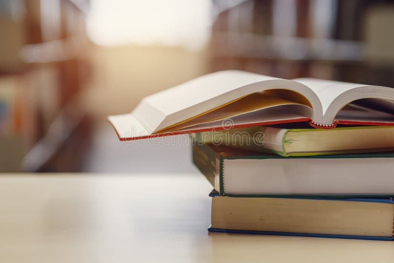 Open Book on Stack of Books in Library at School, University, College ...