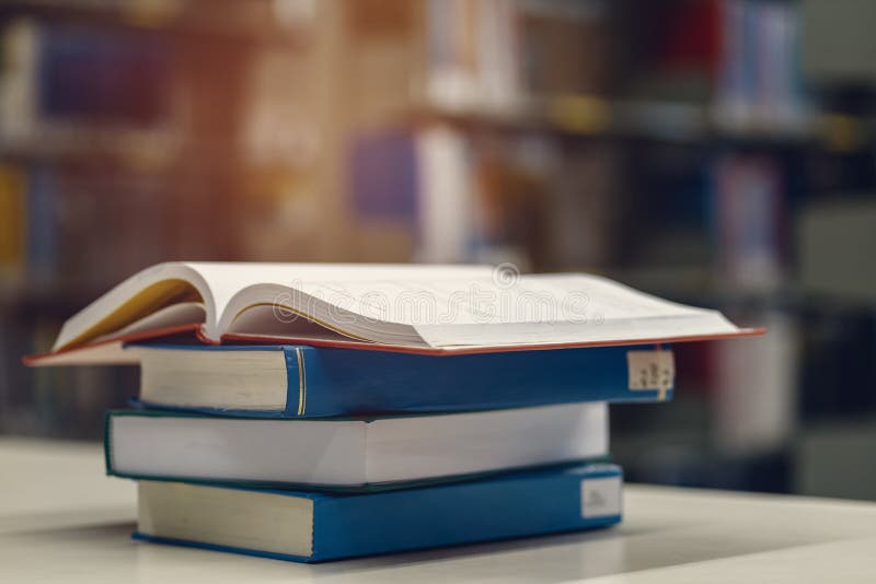 Open Book on Stack of Books in Library at School, University, College ...