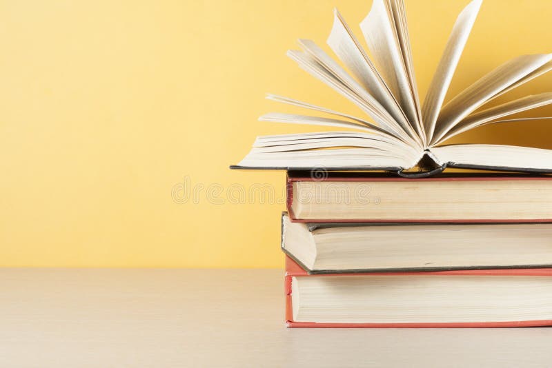 Open Book on Stack of Books on Wooden Table. Education Background. Back ...