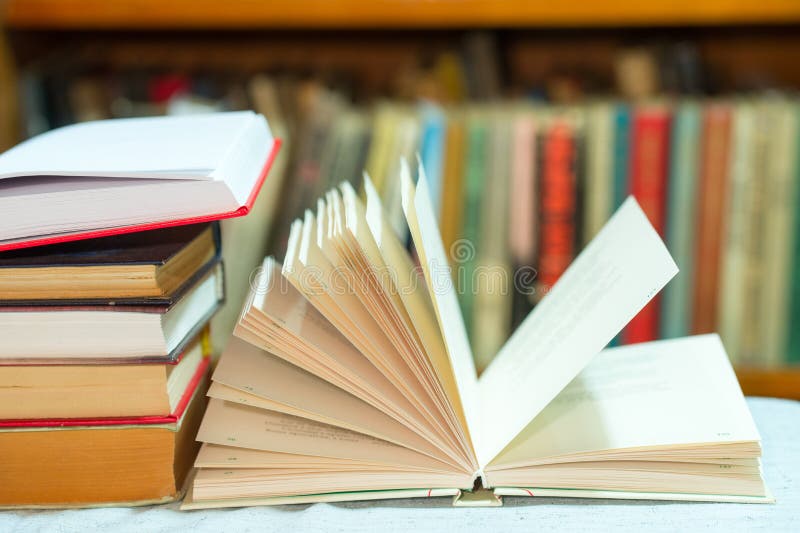 Open Book, Stack of Hardback Books on Table. Top View. Stock Image ...