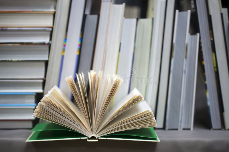 Open Book, Stack of Hardback Books on Table. Top View. Stock Photo ...