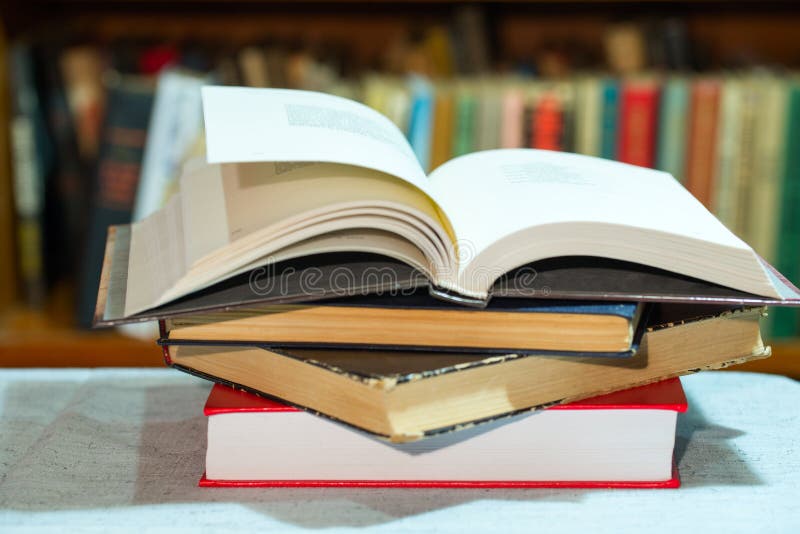 Open Book, Stack of Hardback Books on Table. Top View. Stock Image ...