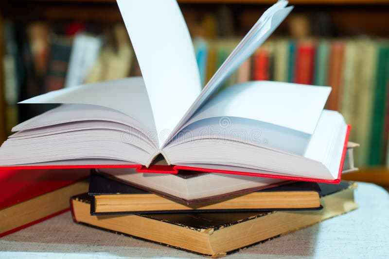 Open Book, Stack of Hardback Books on Table. Top View. Stock Image ...
