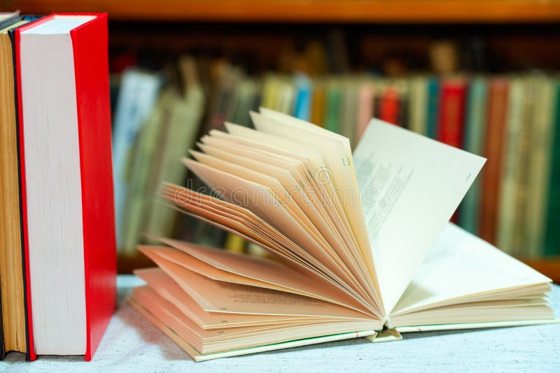 Open Book, Stack of Hardback Books on Table. Top View. Stock Image ...
