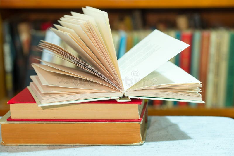 Open Book, Stack of Hardback Books on Table. Top View. Stock Image ...