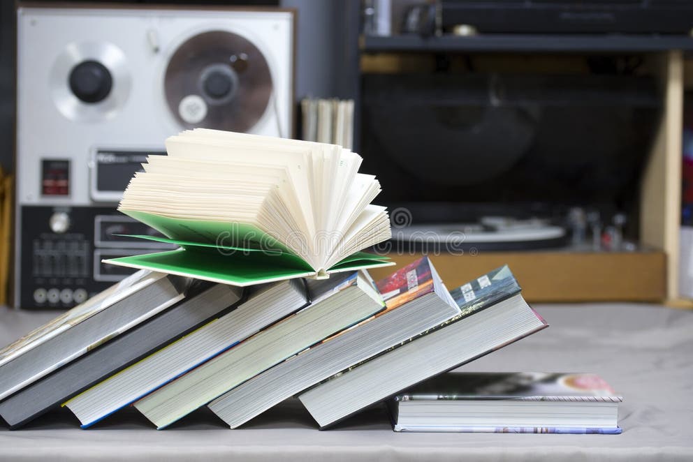 Open Book, Stack of Hardback Books on Table. Top View. Stock Photo ...