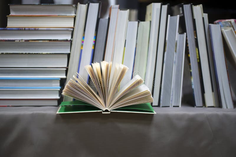 Open Book, Stack of Hardback Books on Table. Top View. Stock Photo ...