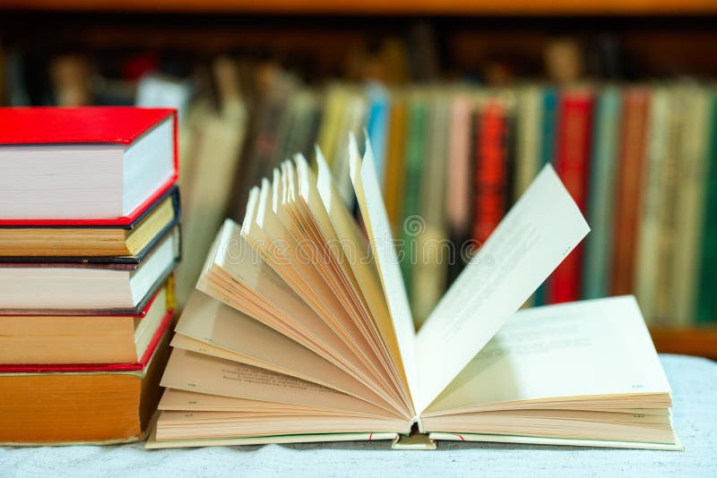 Open Book, Stack of Hardback Books on Table. Top View. Stock Image ...
