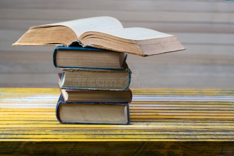 Open Book, Stack of Hardback Books on Wooden Table. Stock Photo - Image ...
