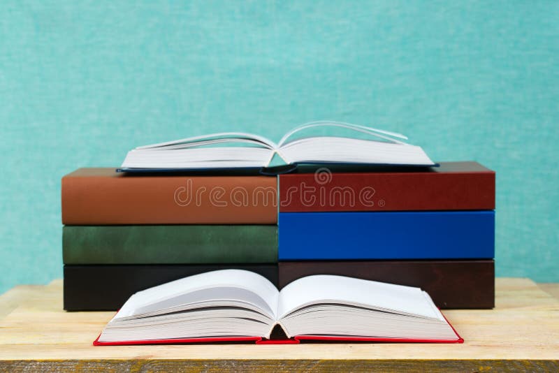 Open Book, Stack of Hardback Books on Wooden Table. Stock Image - Image ...