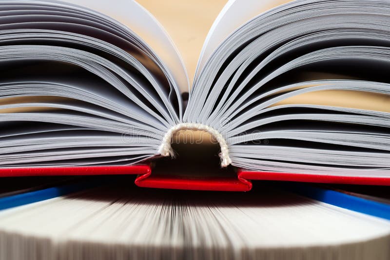 Open Book, Stack of Hardback Books on Wooden Table. Stock Image - Image ...