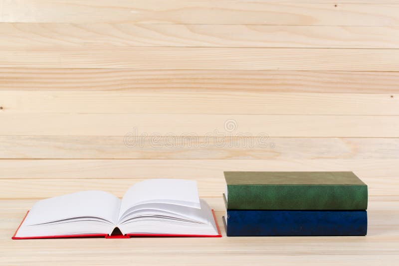 Open Book, Stack of Hardback Books on Wooden Table. Stock Image - Image ...