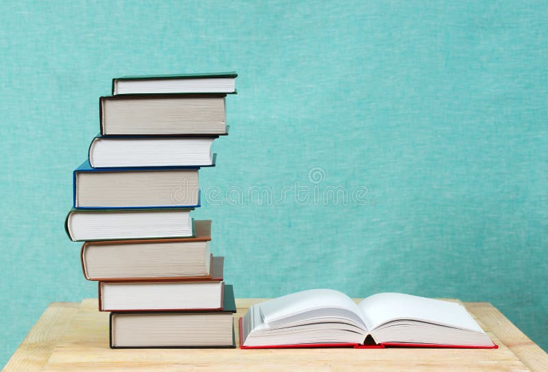 Open Book, Stack of Hardback Books on Wooden Table. Stock Image - Image ...