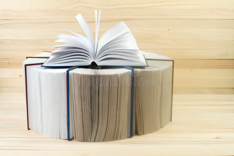 Open Book, Stack of Hardback Books on Wooden Table. Stock Photo - Image ...