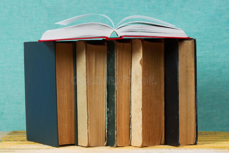 Open Book, Stack of Hardback Books on Wooden Table. Stock Photo - Image ...