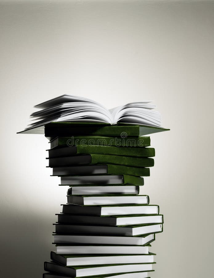 An Open Book on a Stack of Red Books in the Form of a Spiral. Stock ...