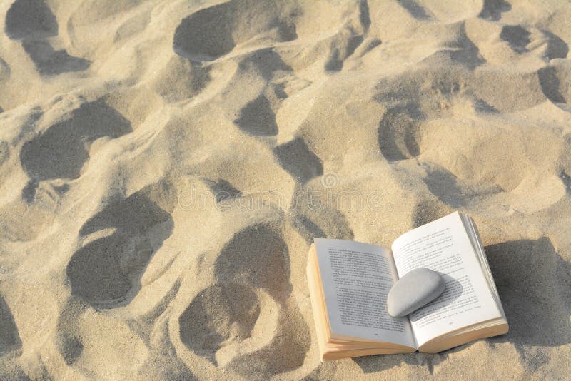 Open Book with Stone on Sandy Beach, Above View. Space for Text Stock ...
