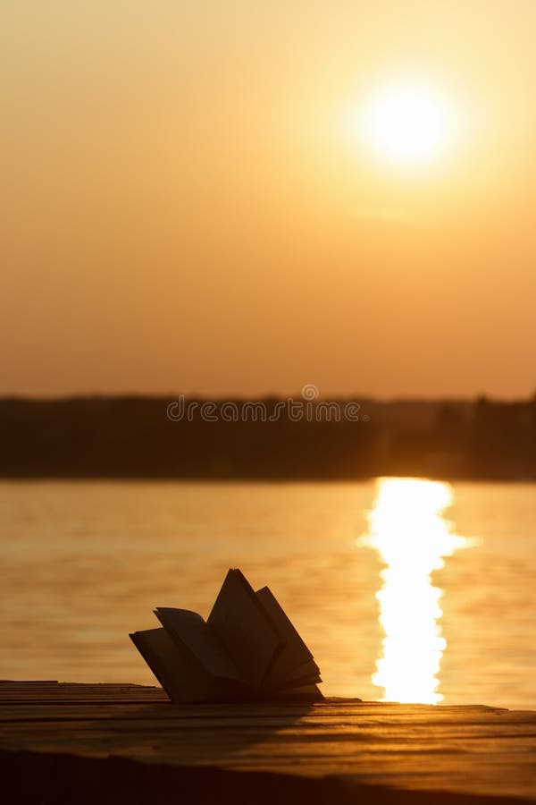 An open book at sunset stock photo. Image of vacation - 102513158