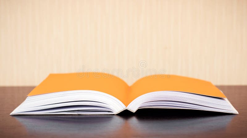 An Open Book on a Table Against the Wall, a Copy of the Space Stock ...