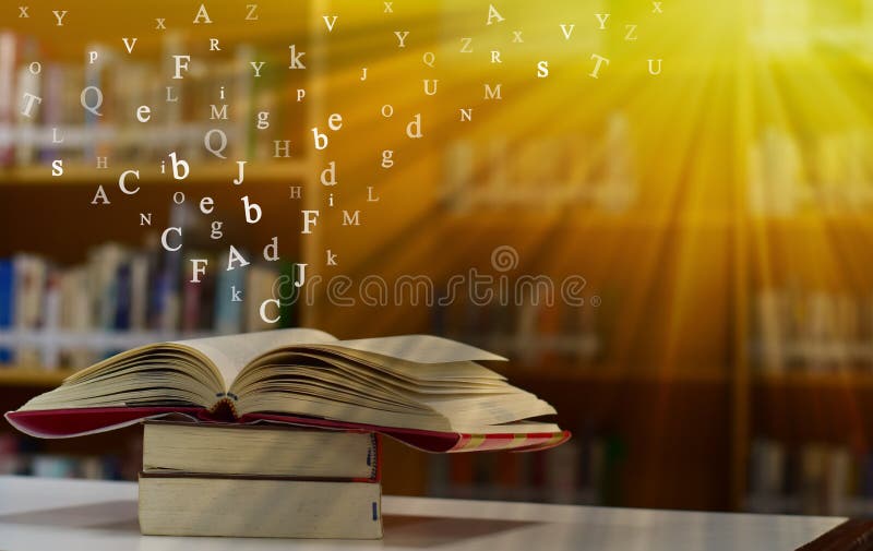Open Book on the Table and English Alphabet Floating Above the Book ...