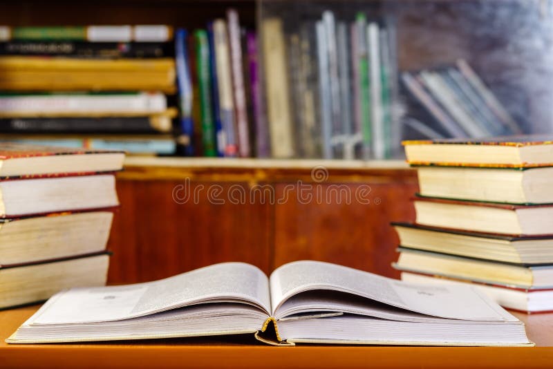 An Open Book on the Table in Front of the Bookcase Stock Image - Image ...