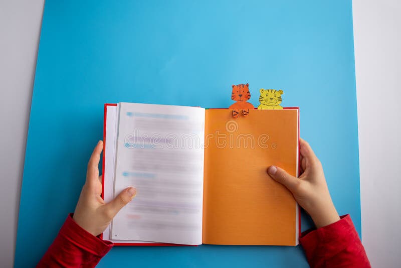 Open Book with Tiger Bookmarks on Blue Background, Copy Space. Top View ...