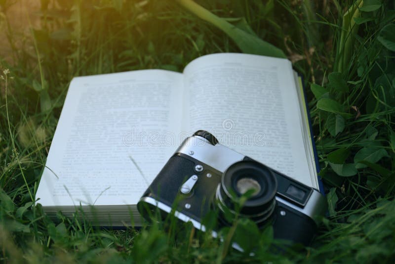 Open Book and Vintage Camera on Green Grass Outdoors Stock Photo ...