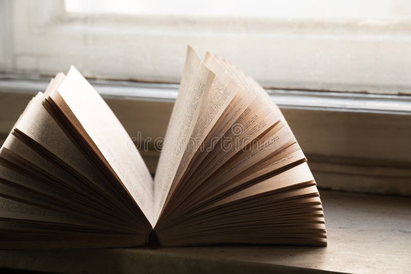 Open Book on Window Sill, with Warm Light Stock Photo - Image of ...