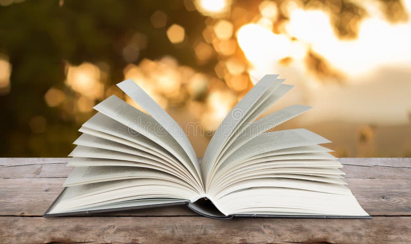 Open Book on Wood Table Outdoors Stock Photo - Image of open, garden ...