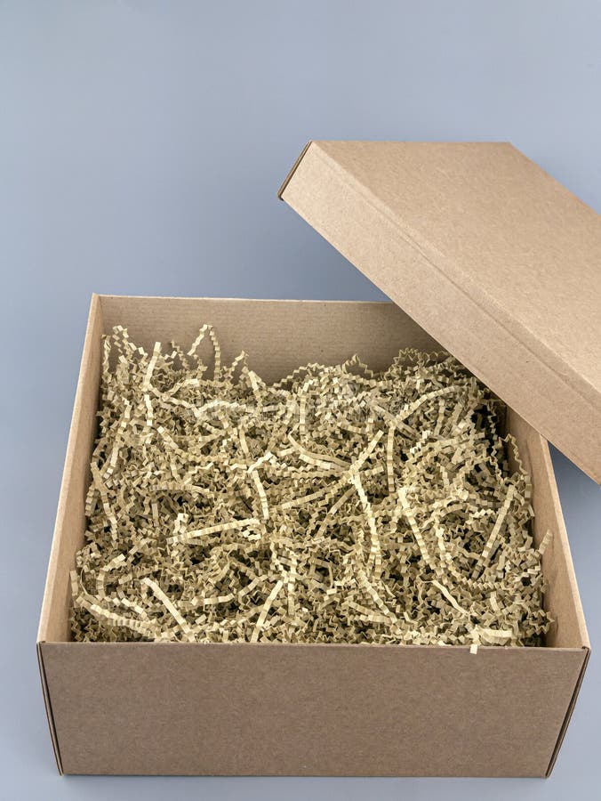 Open Box with Brown Filler on Gray Background Stock Photo - Image of ...