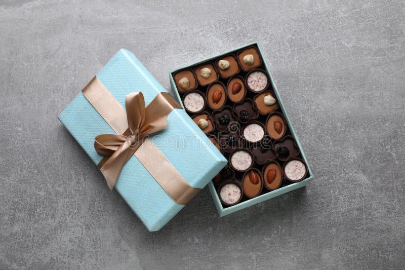 Open Box of Delicious Chocolate Candies on Light Grey Table, Top View ...