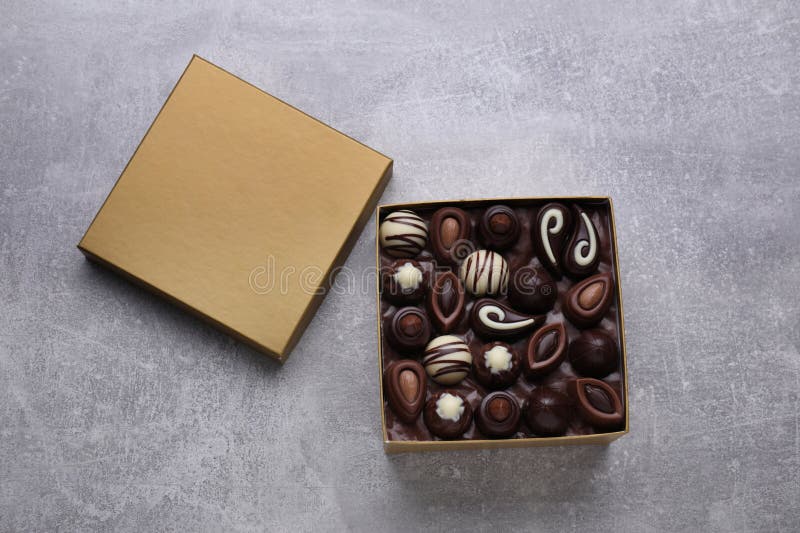 Open Box of Delicious Chocolate Candies on Light Grey Table, Top View ...
