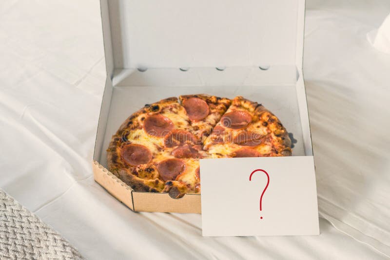 Open Box of Pizza on the Big Bed and Card with Question Mark. Concept ...