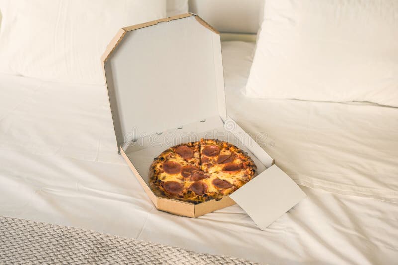 Open Box of Pizza on the Big Bed with Empty Card for Text. Concept ...