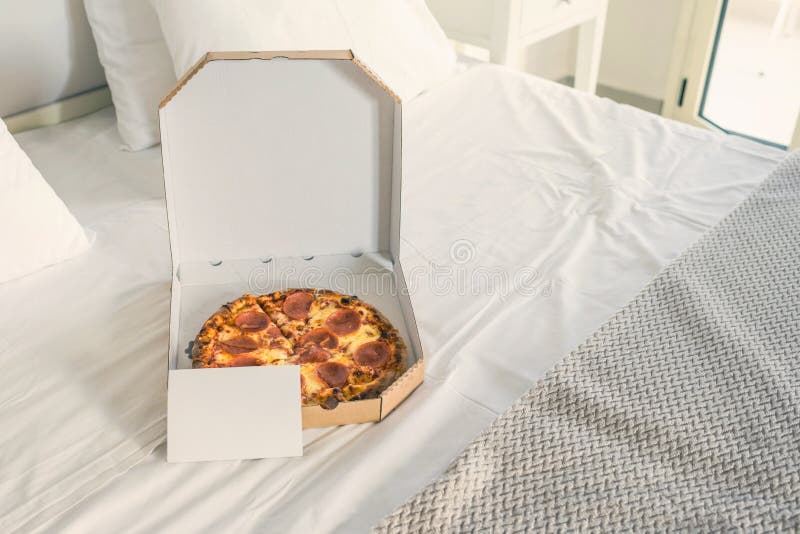 Open Box of Pizza on the Big Bed with Empty Card for Text. Concept ...