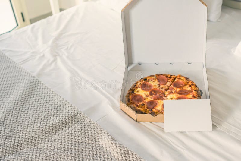 Open Box of Pizza on the Big Bed with Empty Card for Text. Concept ...