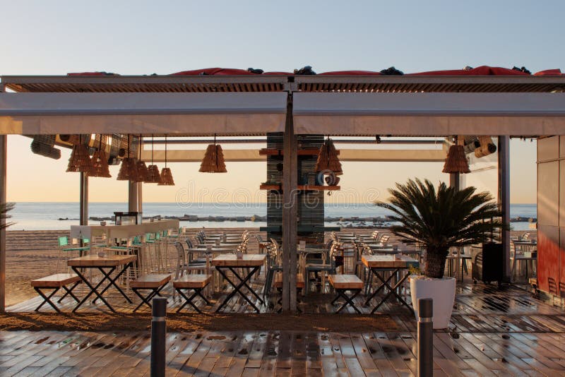 An Open Cafe with a Bar Desk with Wooden Tables and Chairs on the ...