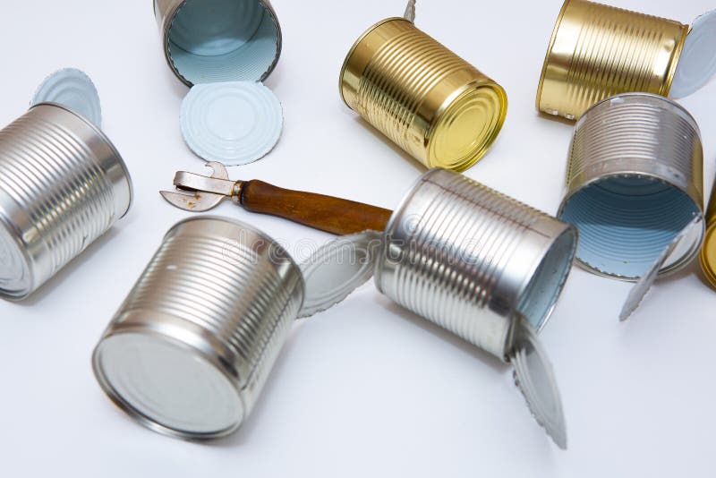 Open cans and a can opener stock photo. Image of isolated - 227656144