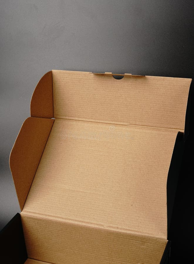 An Open Cardboard Box on a Black Background. Dimmed Lights Stock Photo ...