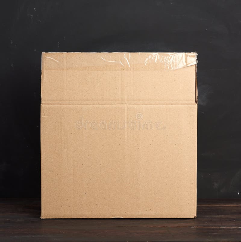 Open Cardboard Box Stands on a Brown Table, Concept of Moving and ...