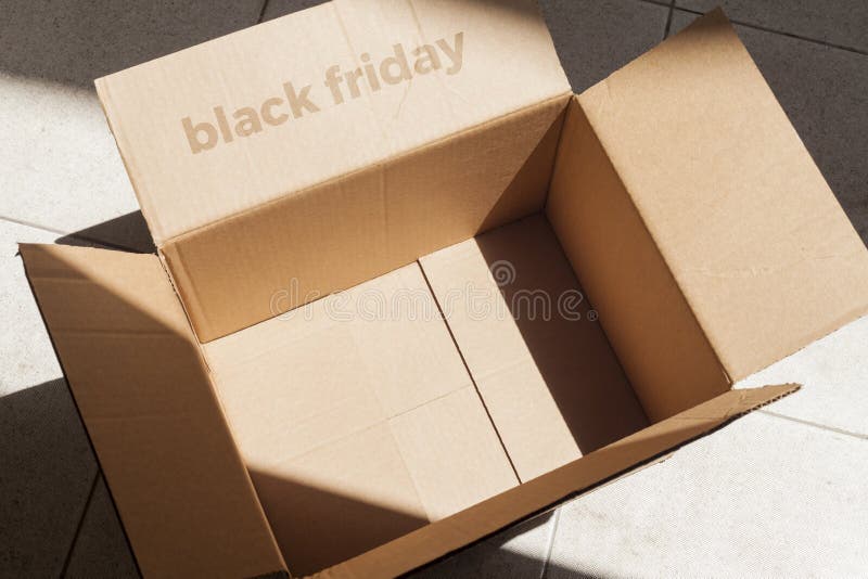 Open Cardboard Box with Sunlight Written on Black Friday. Stock Image ...