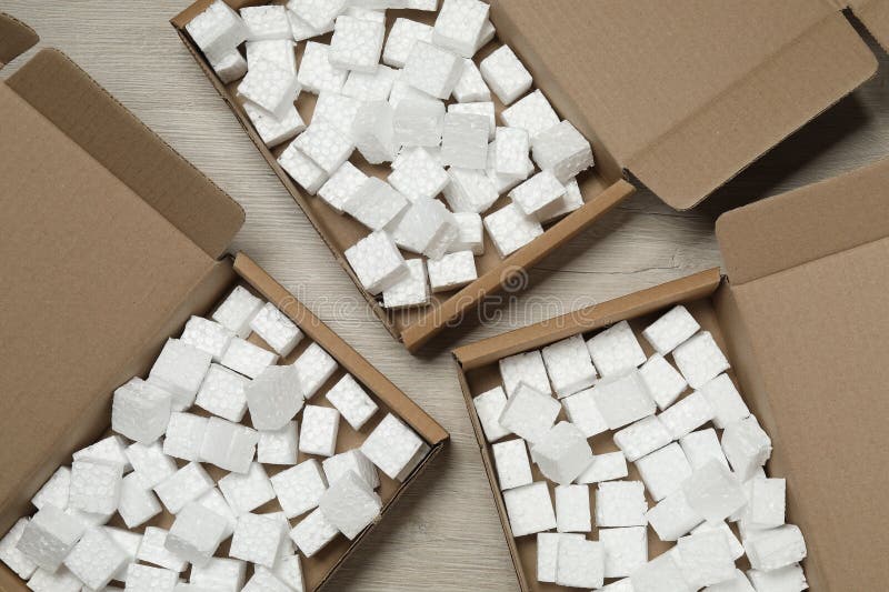 Open Cardboard Boxes with Pieces of Polystyrene Foam on Wooden Floor ...