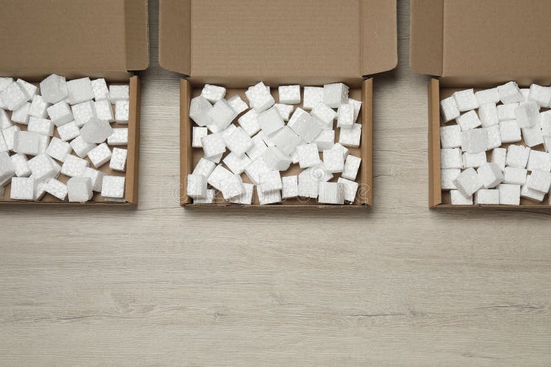 Open Cardboard Boxes with Pieces of Polystyrene Foam on Wooden Floor ...