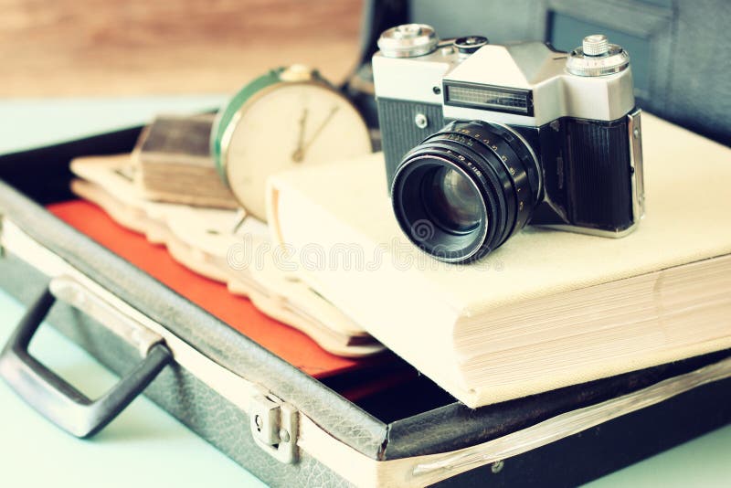 Open Case with Old Camera Sunglasses and Clock in Front of Seascape ...