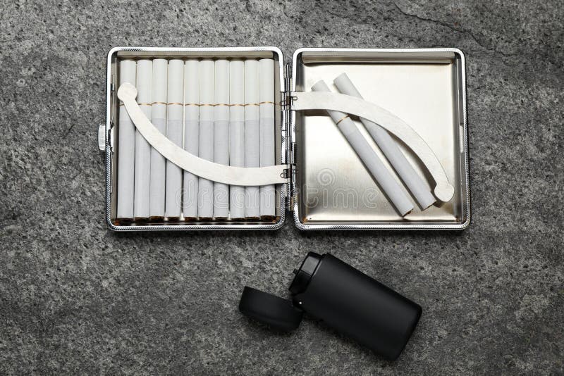 Open Case with Tobacco Filter Cigarettes and Lighter on Grey Table ...