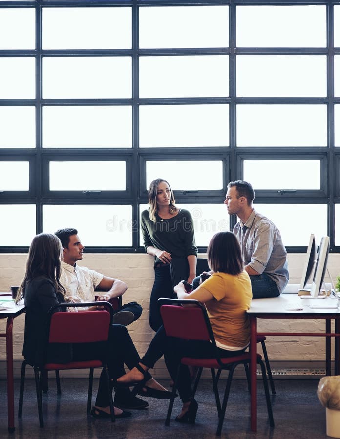 We are an Open Channel for Creative Ideas. Creative Employees Having a Meeting in a Modern ...