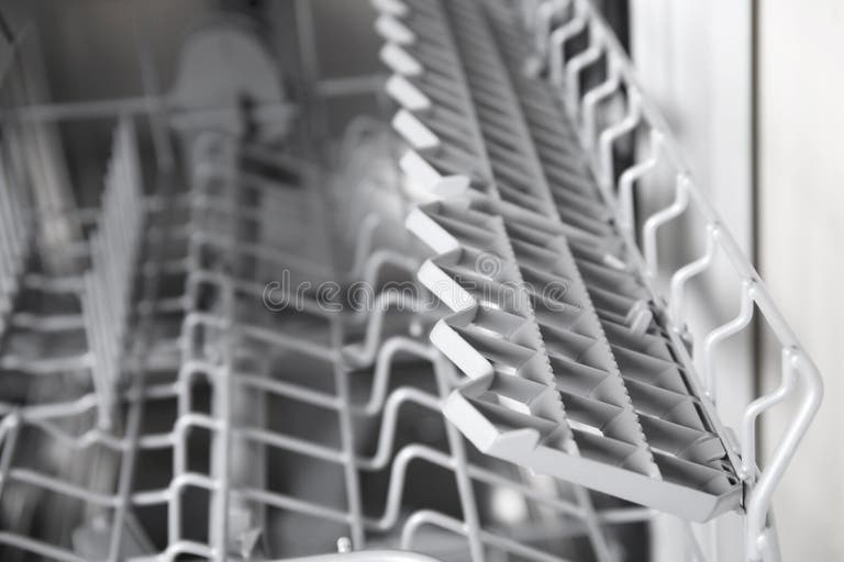 Open Clean Empty Dishwasher in Kitchen, Closeup Stock Photo - Image of ...