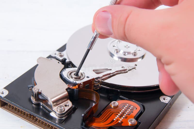 Open Computer Hard Disk Drive HDD and Hand with a Screwdriver Closeup ...