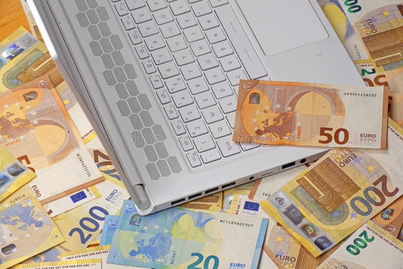 Open Computer and a Lot of Money Around Stock Image - Image of currency ...